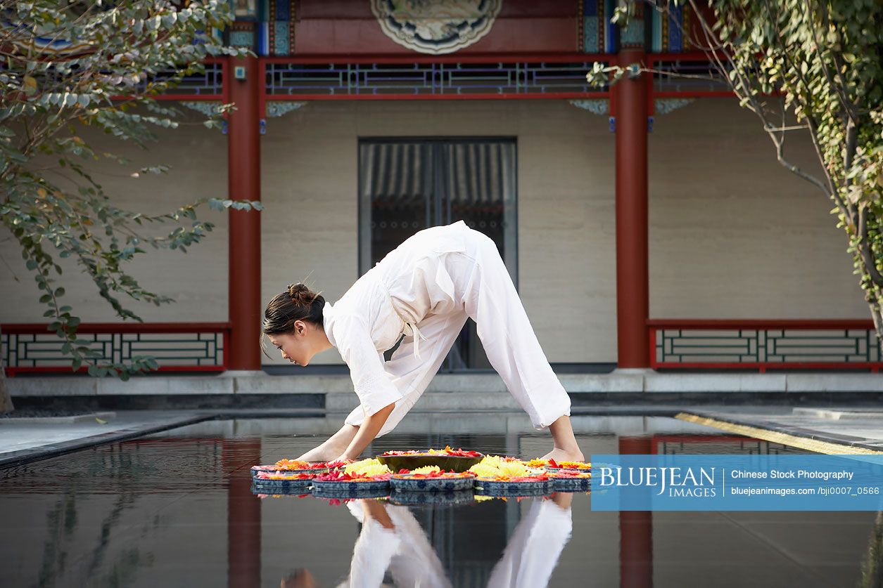 Chinese Woman Stretching In Middle Of A Pond-High-res stock photo for download