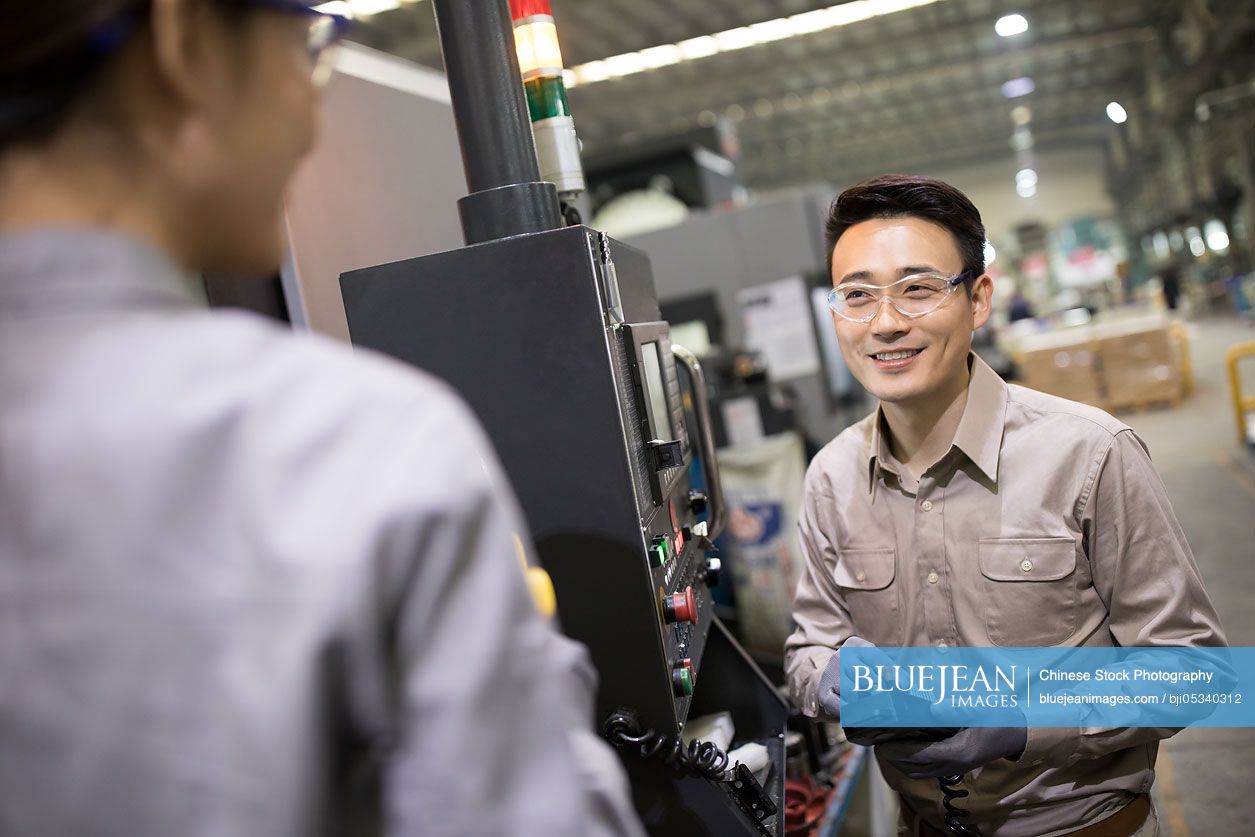Confident Chinese engineers talking in the factory-High-res stock photo ...