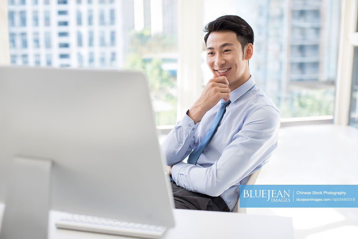 Young Chinese businessman using computer in office-High-res stock photo for download