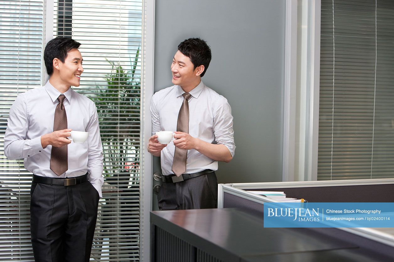Two young Chinese businessmen taking a coffee break-High-res stock ...