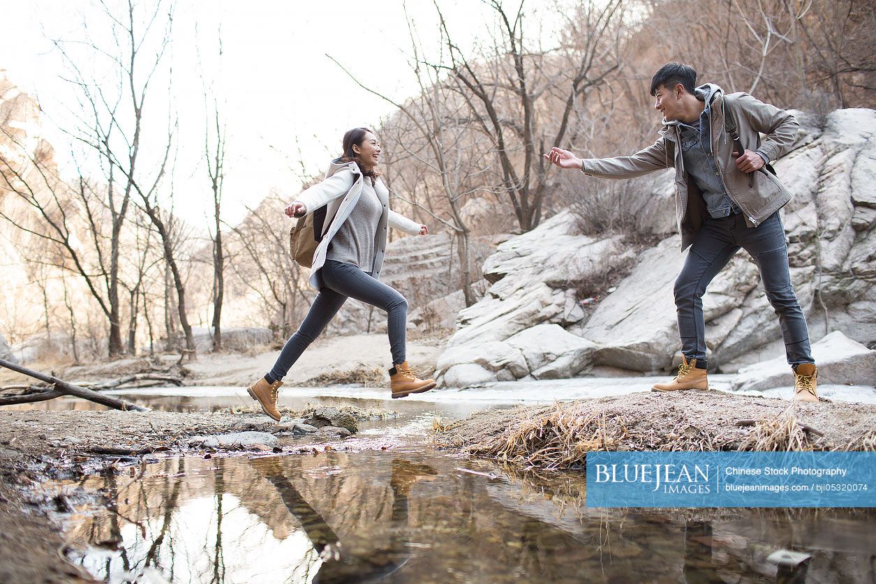 Happy young Chinese couple enjoying winter outing-High-res stock photo for download