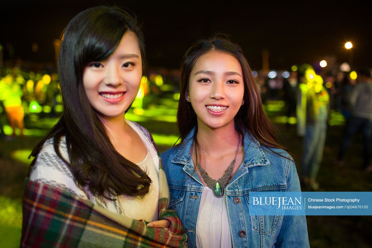 Happy young Chinese women at music festival-High-res stock photo for download