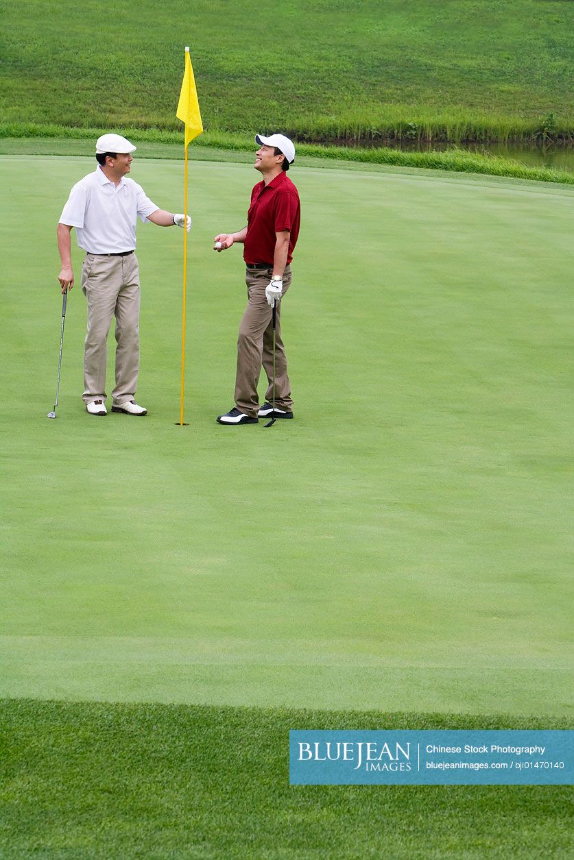 Two Chinese golfers on the green-High-res stock photo for download