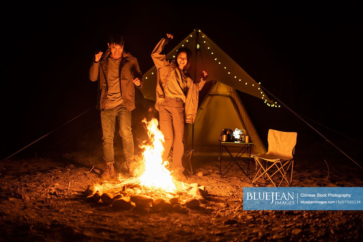 Happy young Chinese couple camping outdoors-High-res stock photo for ...
