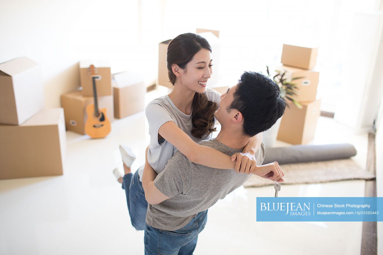 Happy young Chinese couple moving to a new house-High-res stock photo ...