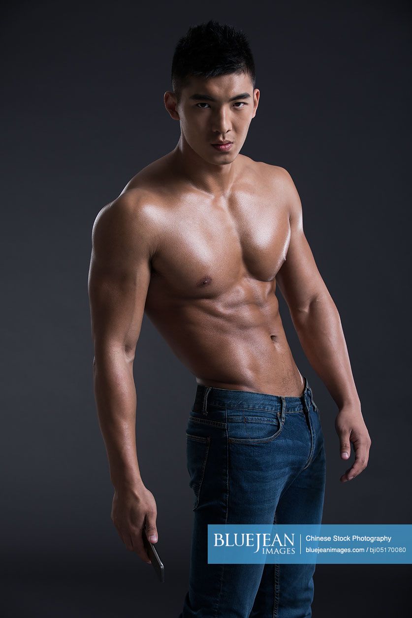 Young Chinese muscular man with a smart phone-High-res stock photo for ...