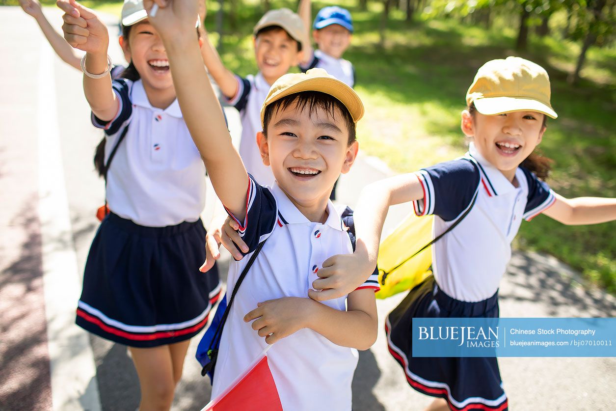 Cheerful Chinese school children relaxing in park-High-res stock photo ...