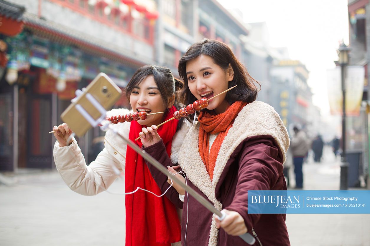 Young Chinese women taking self portrait with a smart phone-High-res ...