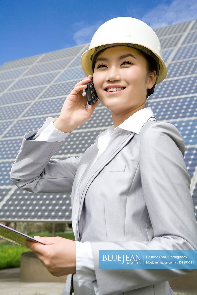 Portrait of a Chinese engineer in front of solar panels-High-res stock ...