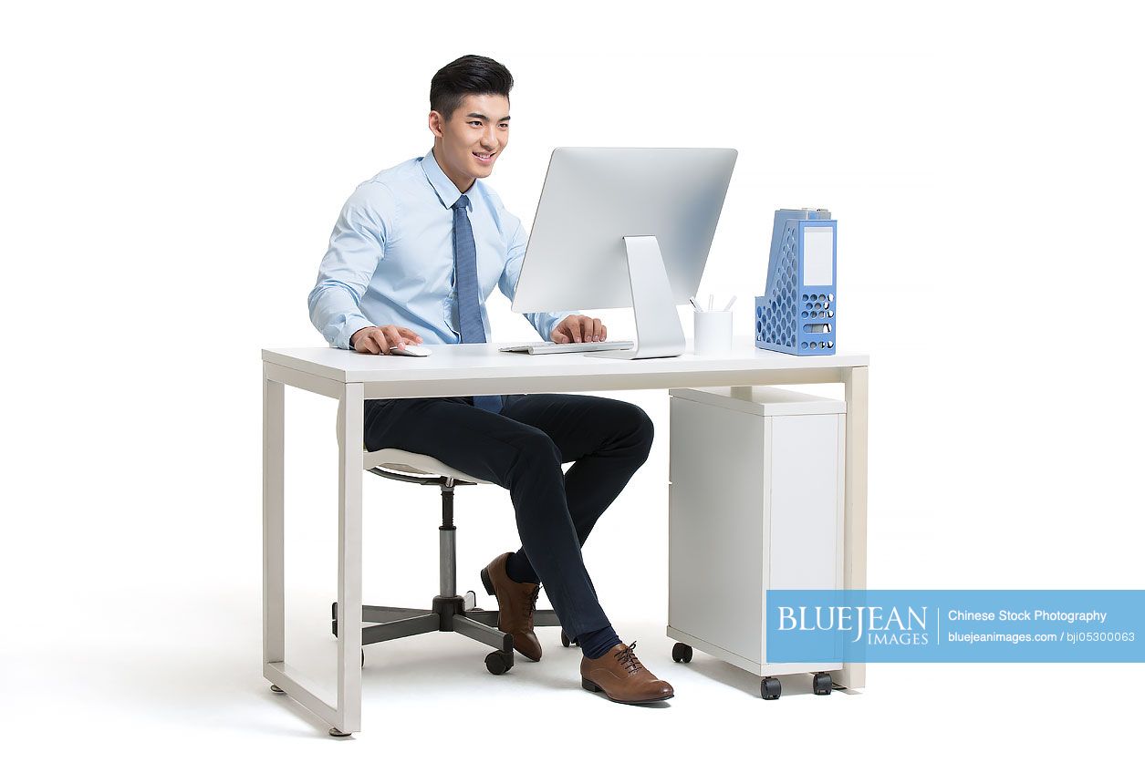 Cheerful young Chinese businessman working in office-High-res stock ...