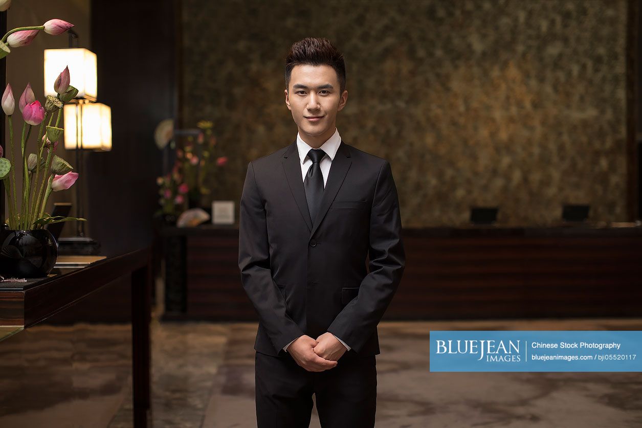 Portrait of confident Chinese hotel receptionist-High-res stock photo ...