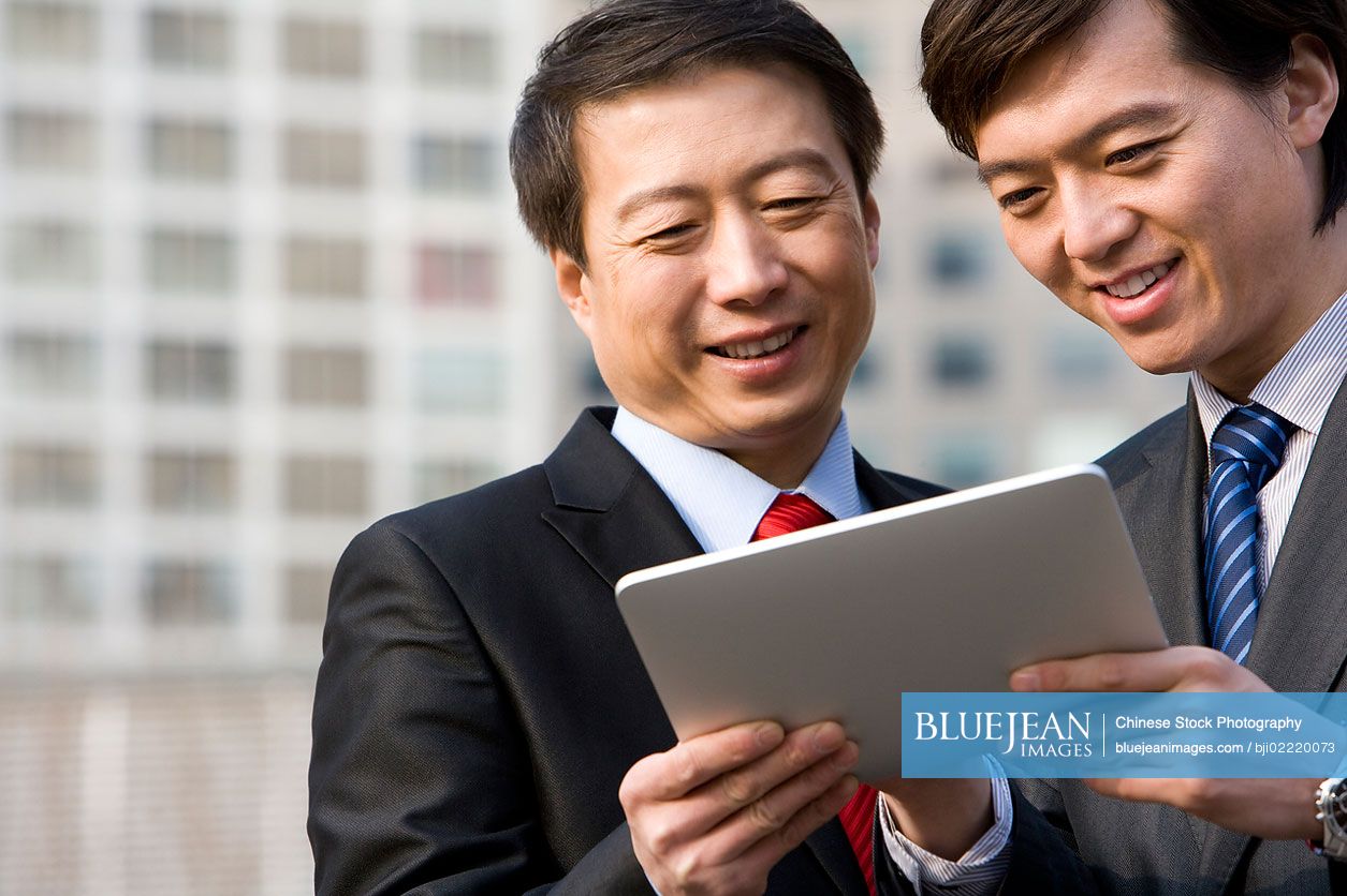 Chinese business partners using a tablet together-High-res stock photo ...