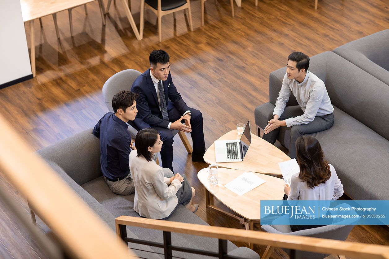 Confident Chinese business people talking in office-High-res stock photo for download