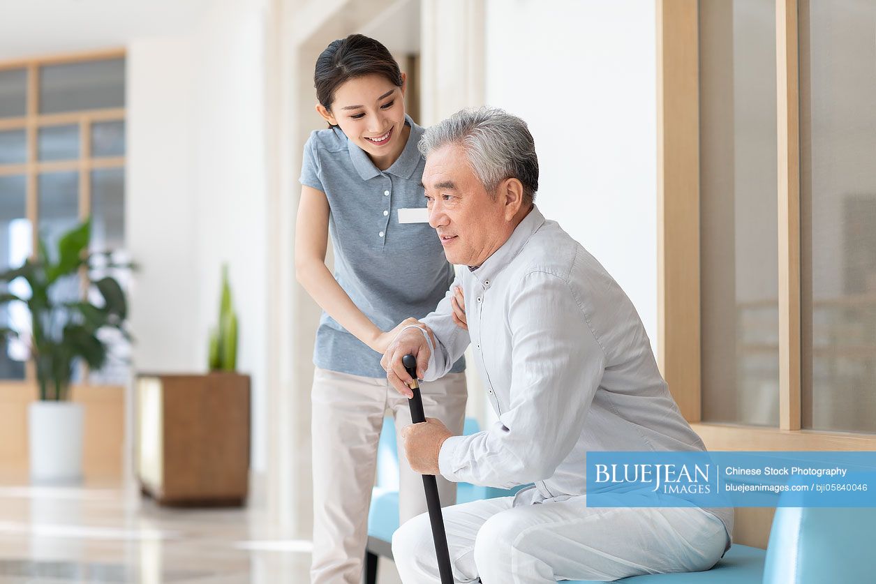 Chinese nursing assistant taking care of senior man-High-res stock ...
