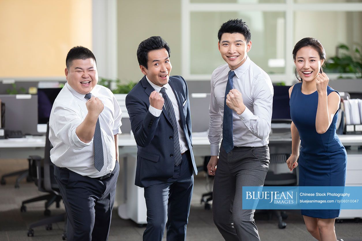 Chinese business team punching the air in office-High-res stock photo ...