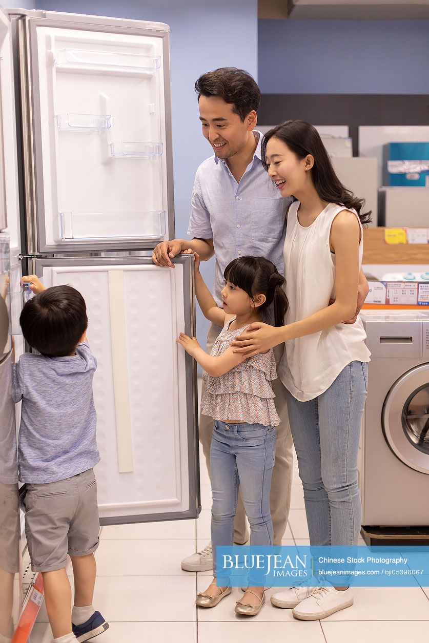 Happy young Chinese family shopping in supermarket-High-res stock photo ...