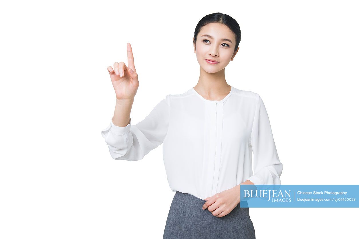 Young Chinese woman using finger to point-High-res stock photo for download