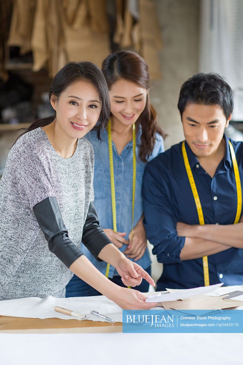 Chinese fashion designers talking in studio-High-res stock photo for download