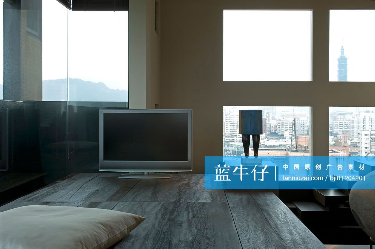 View of cityscape through window with computer monitor on desk with ...