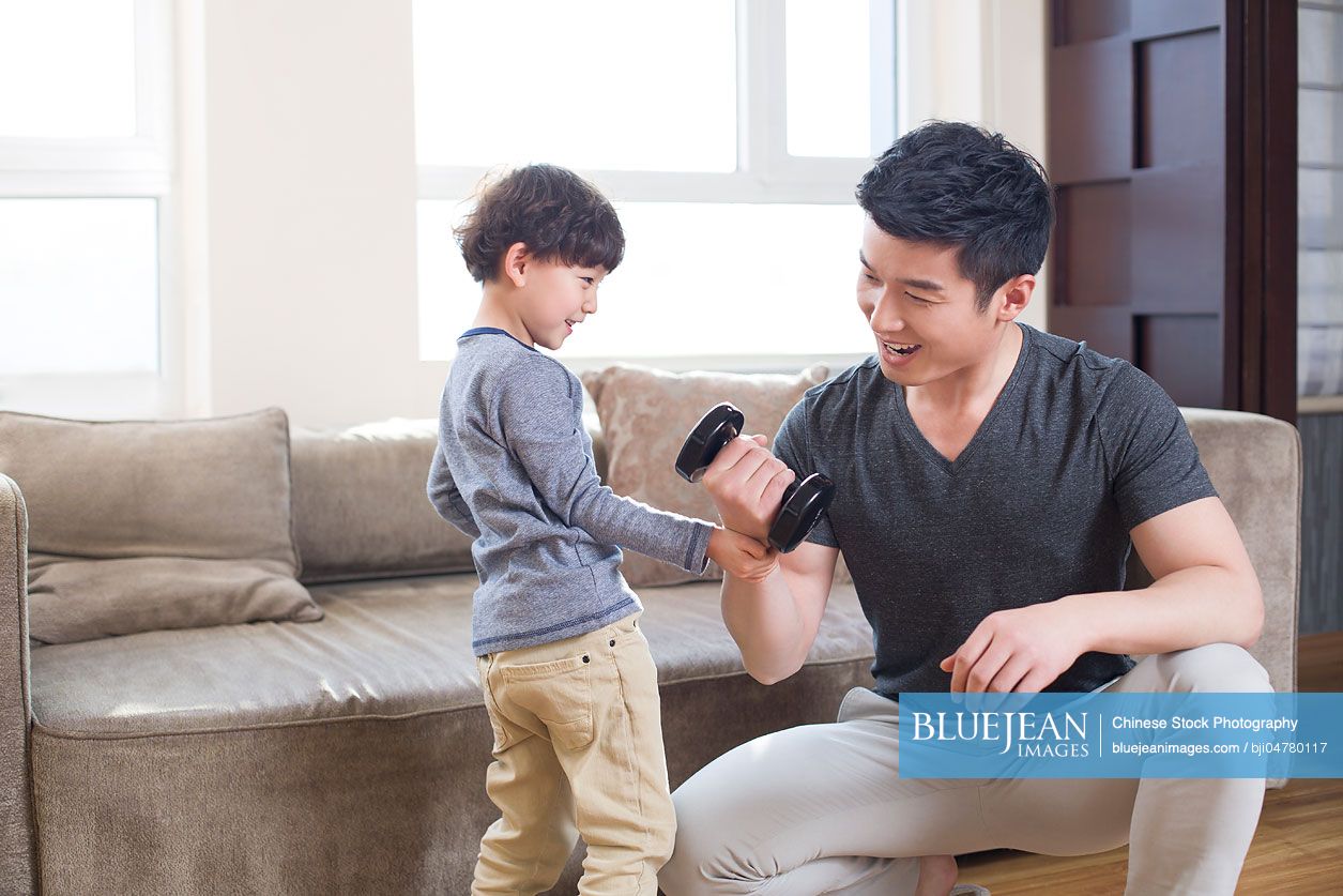 Young Chinese father and son exercising at home-High-res stock photo ...
