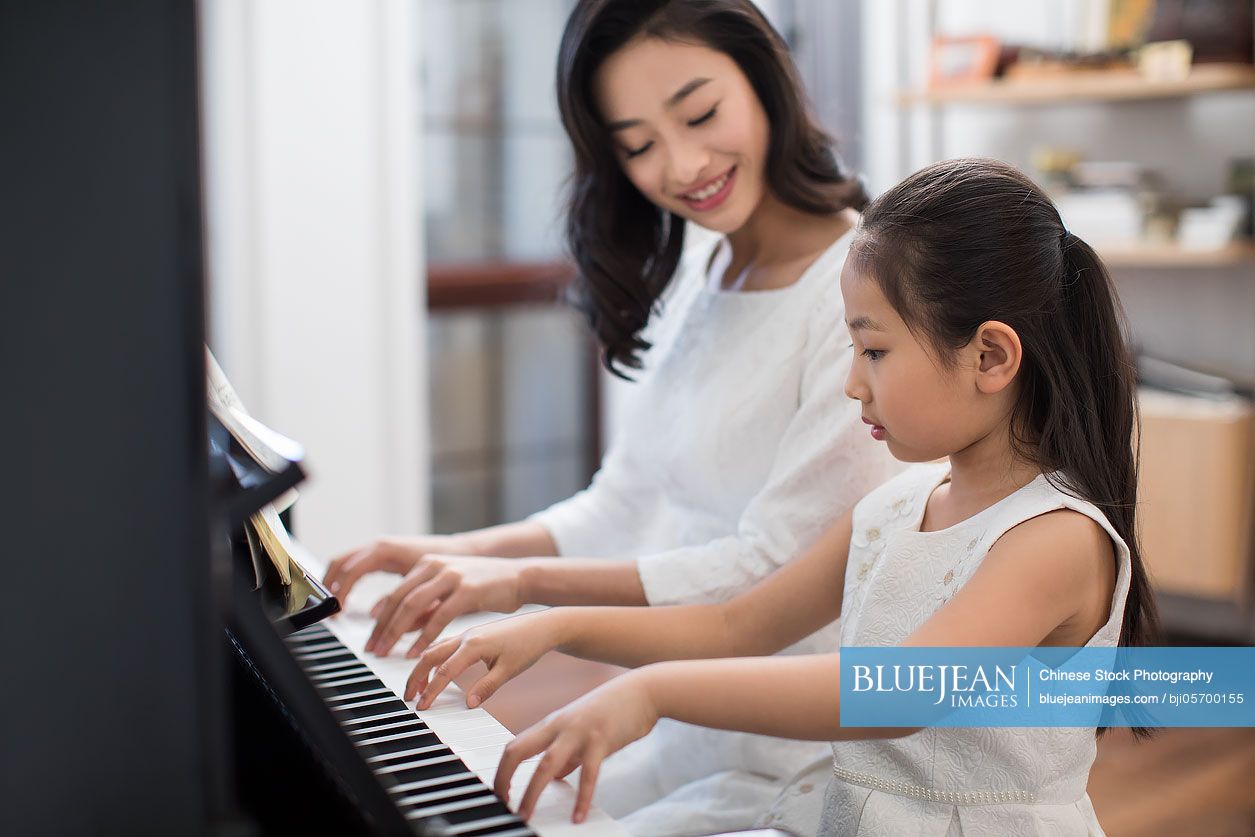 Chinese mother teaching daughter to play the piano-High-res stock photo ...
