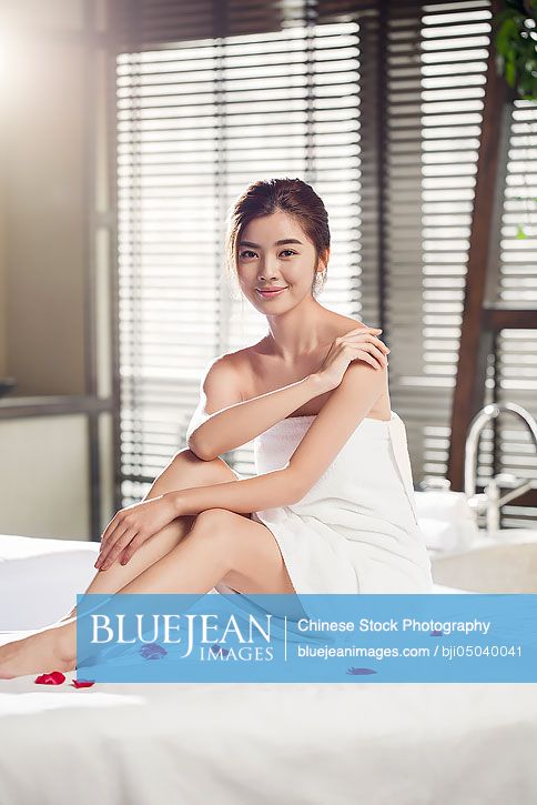Beautiful young Chinese woman relaxing on massage table-High-res stock photo for download