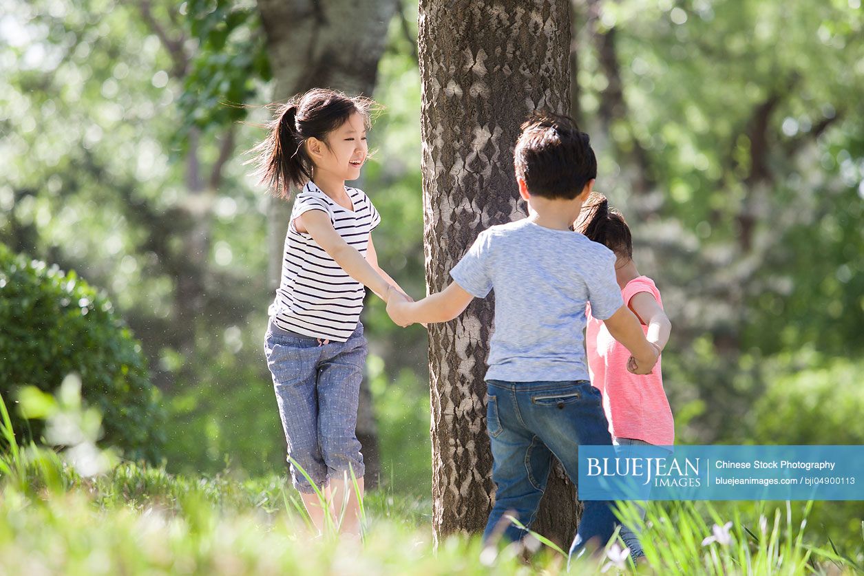 Happy Chinese children playing in woods-High-res stock photo for download