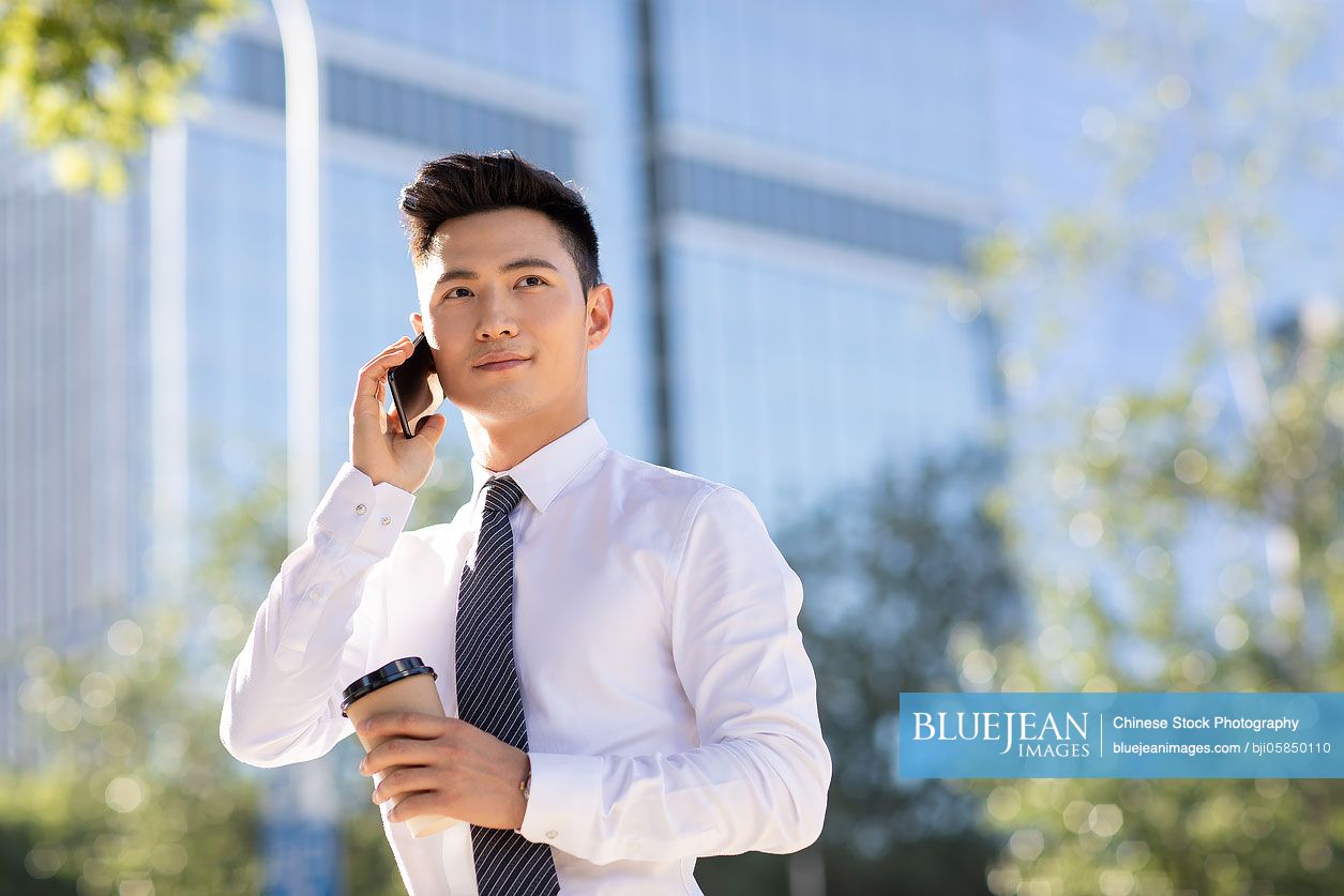 Confident young Chinese businessman on the phone-High-res stock photo ...