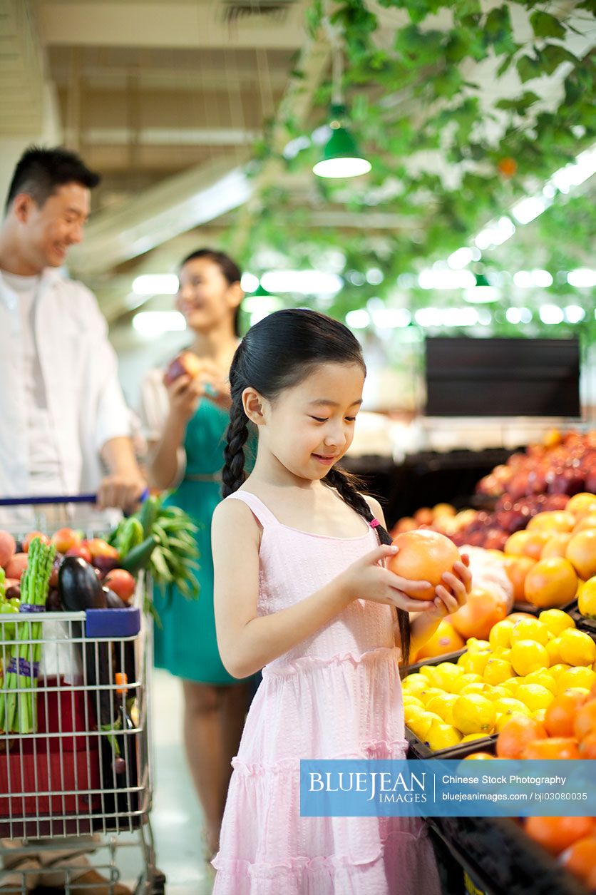 Chinese family shopping in supermarket-High-res stock photo for download