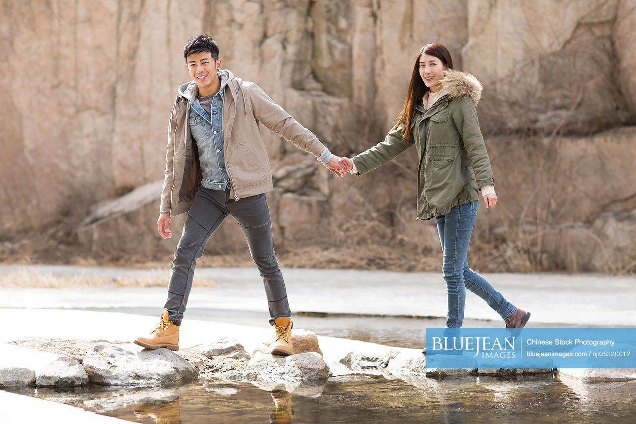 Happy young Chinese couple enjoying winter outing-High-res stock photo for download