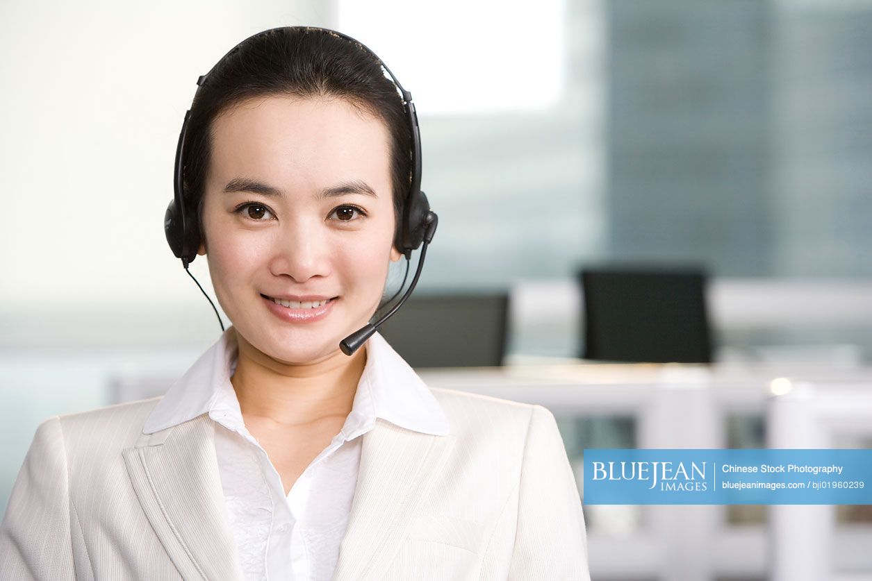 Chinese office worker with a headset-High-res stock photo for download