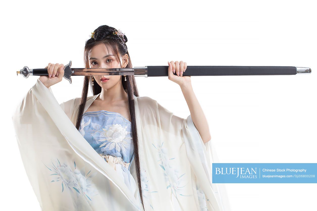 Young Chinese woman in ancient costume holding a sword-High-res stock ...