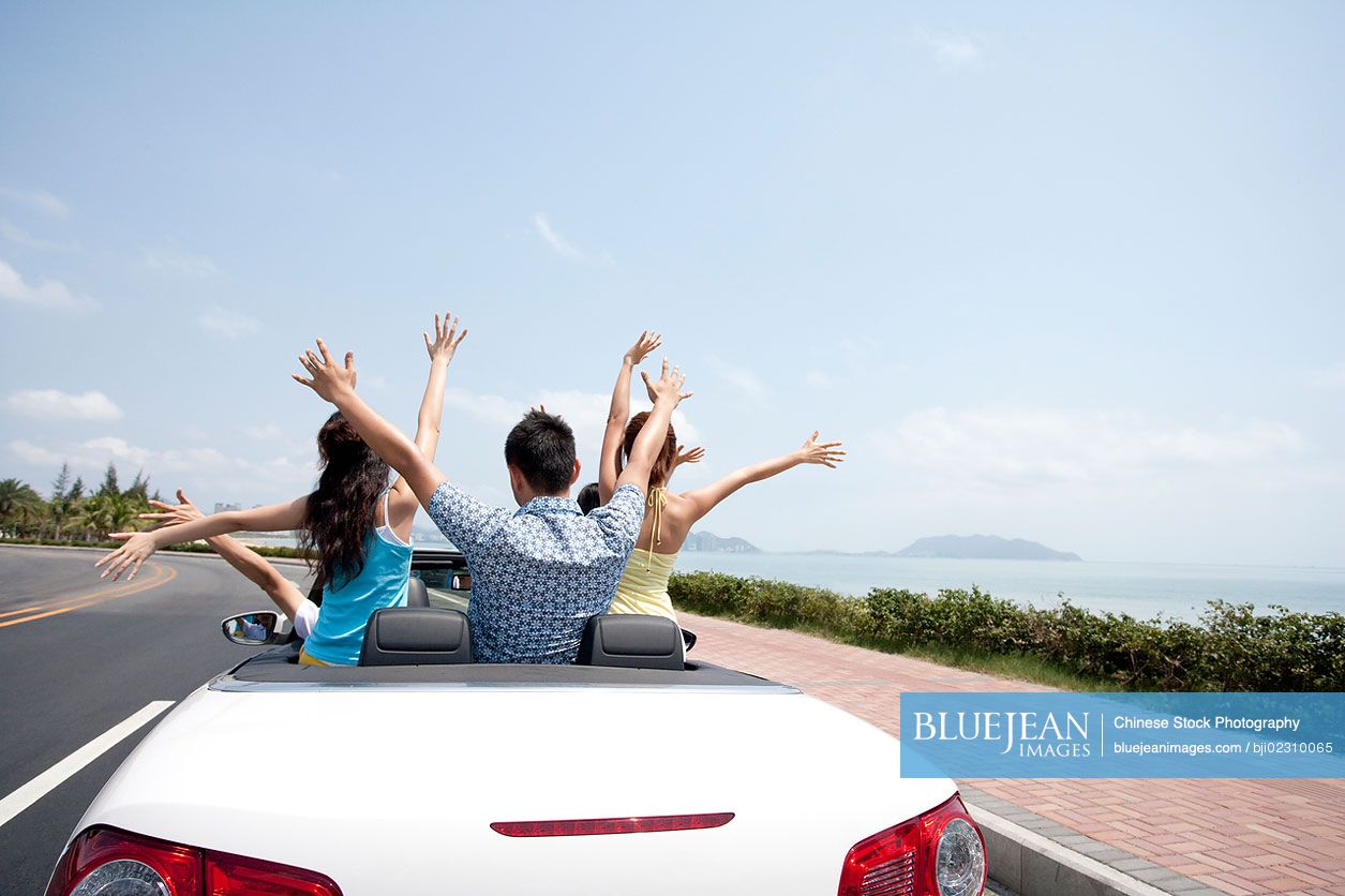 Chinese friends having fun in a convertible-High-res stock photo for ...