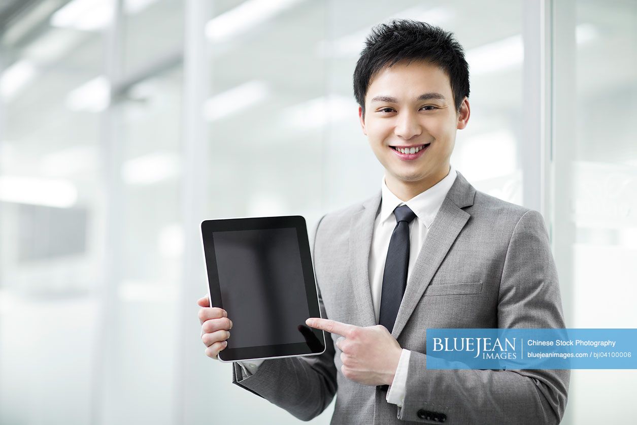 Young Chinese businessman with digital tablet-High-res stock photo for ...