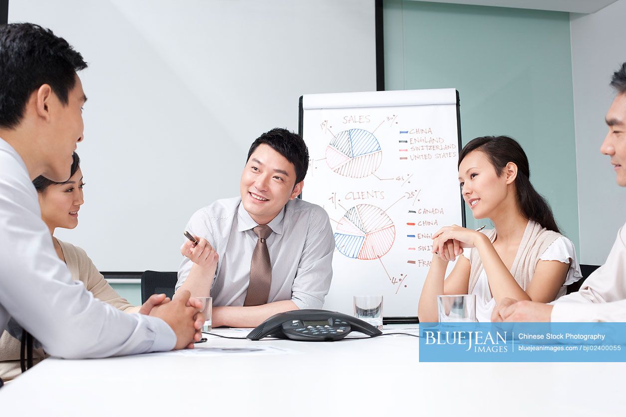Chinese business executive discussing with business team-High-res stock ...