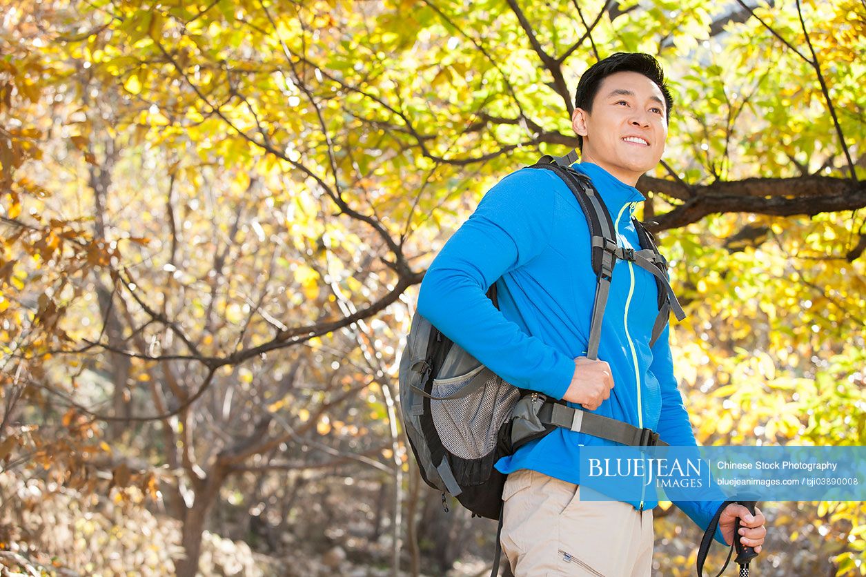 Happy male Chinese backpacker on a hike-High-res stock photo for download