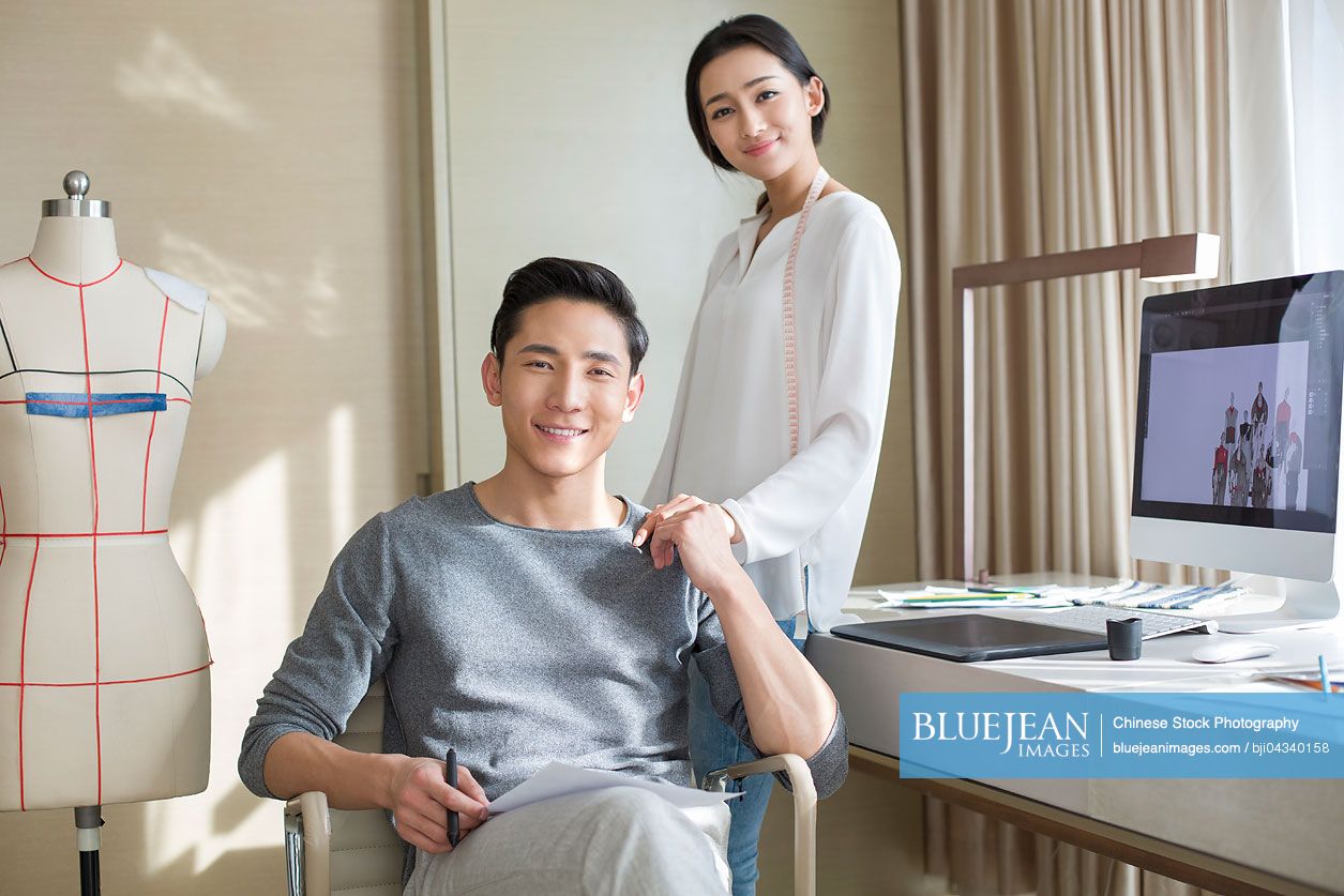 Young Chinese couple designing clothing together-High-res stock photo for download