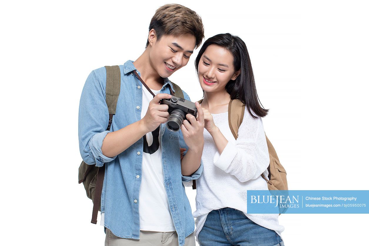 Happy young Chinese couple taking photos with digital camera-High-res ...