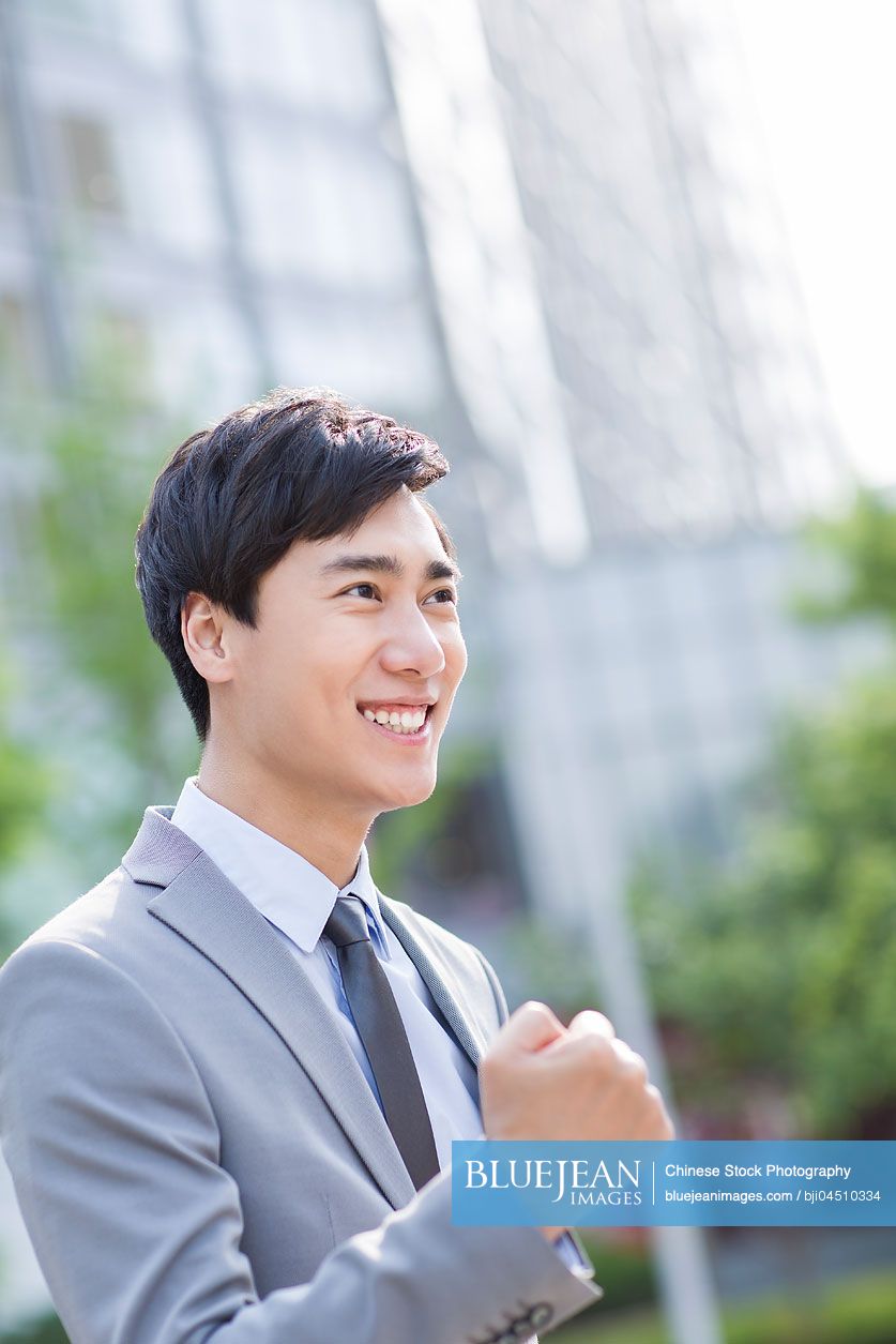 Young Chinese businessman cheering-High-res stock photo for download