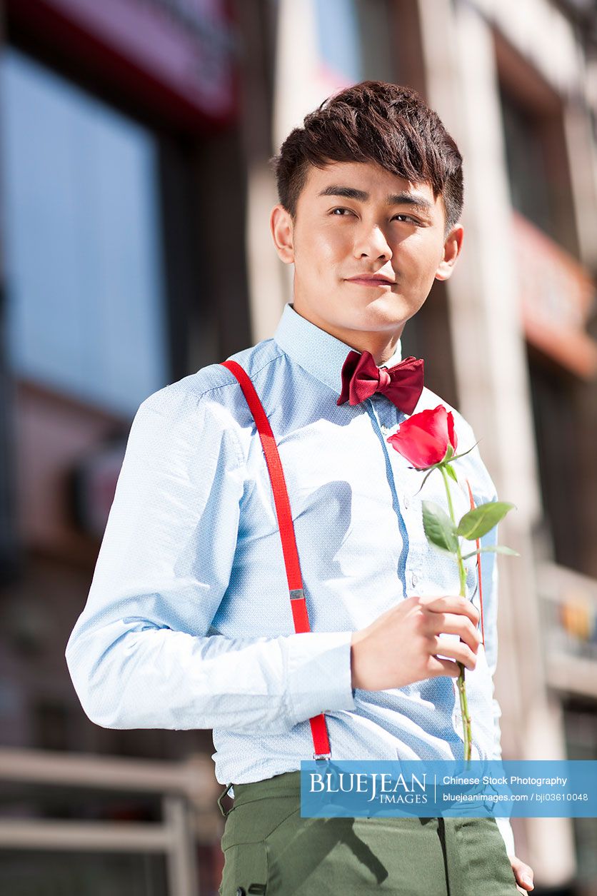 Stylish young Chinese man with rose in hand-High-res stock photo for ...