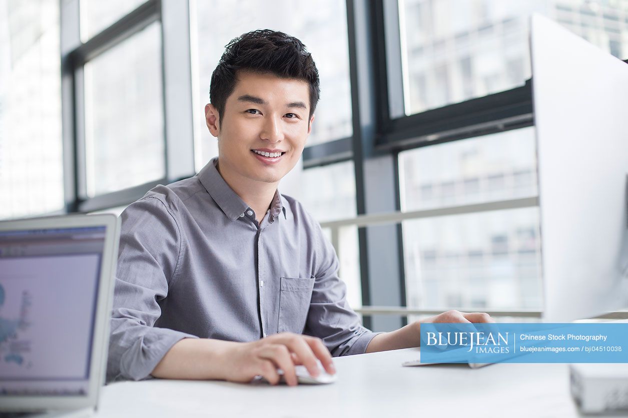 Young Chinese businessman using computer in office-High-res stock photo ...