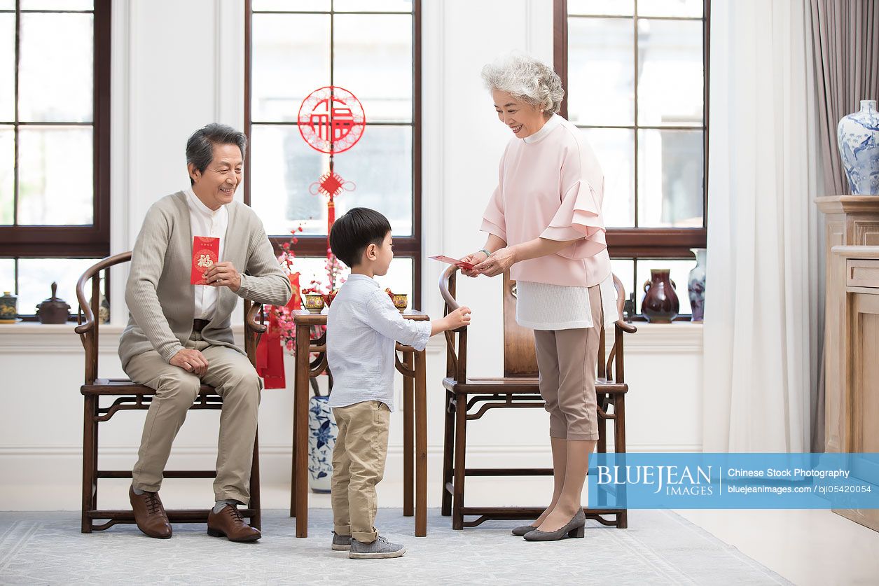 Chinese grandparents giving red pockets to grandson-High-res stock ...