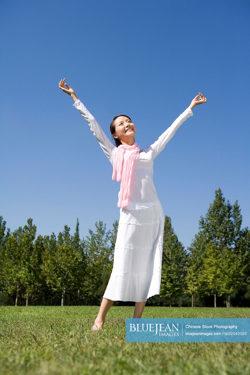 Happy young Chinese woman enjoying the sun-High-res stock photo for download