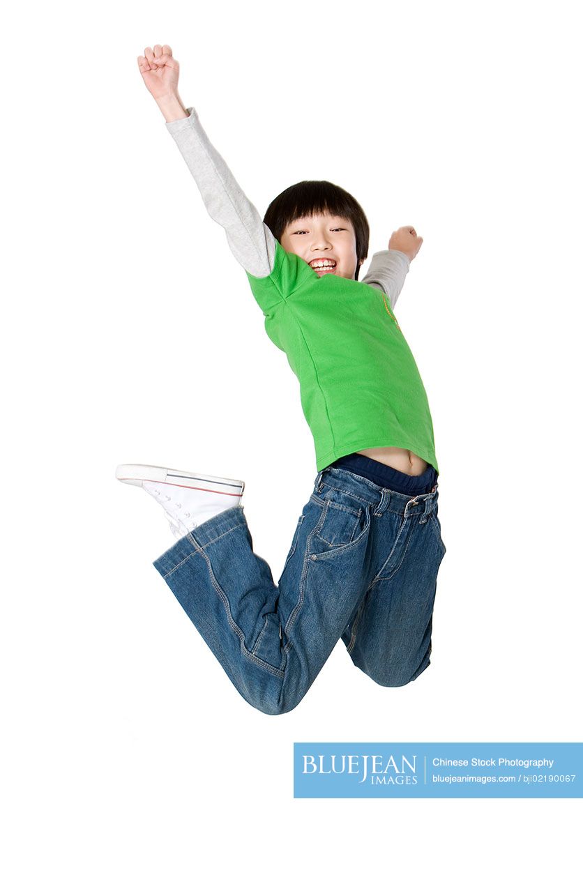 Young Chinese boy jumping up with excitement-High-res stock photo for ...