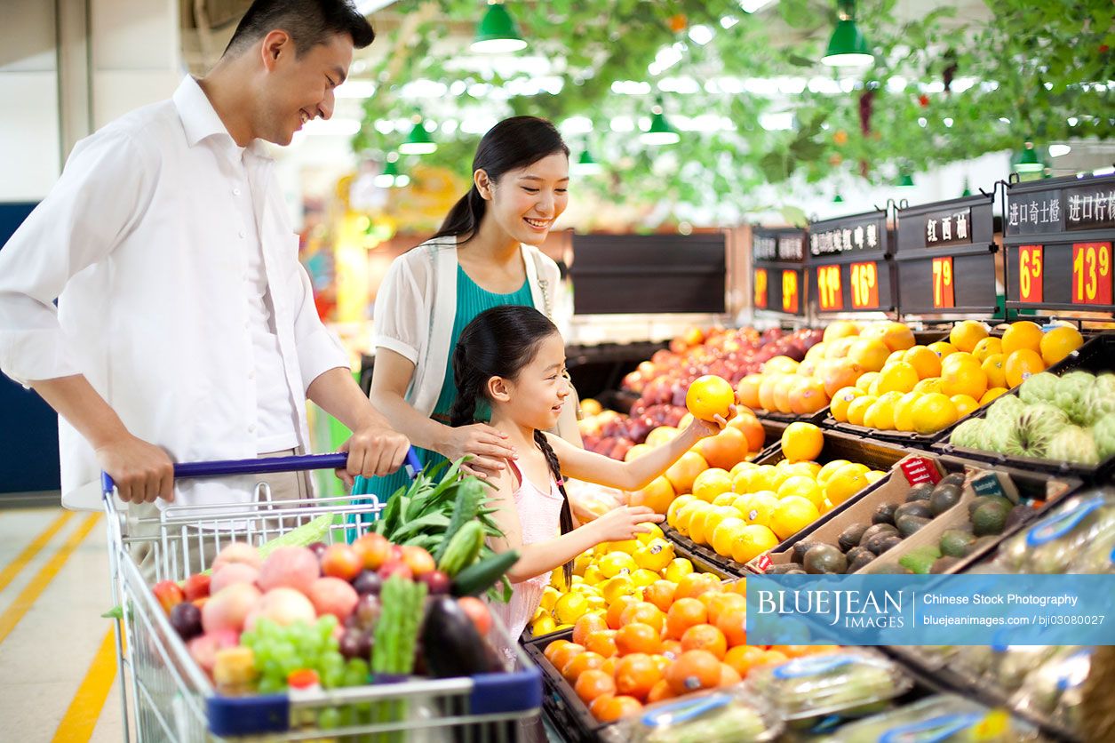 Chinese family shopping in supermarket-High-res stock photo for download