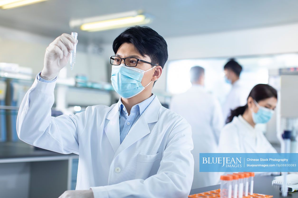 Chinese scientists examining medical sample in laboratory-High-res ...