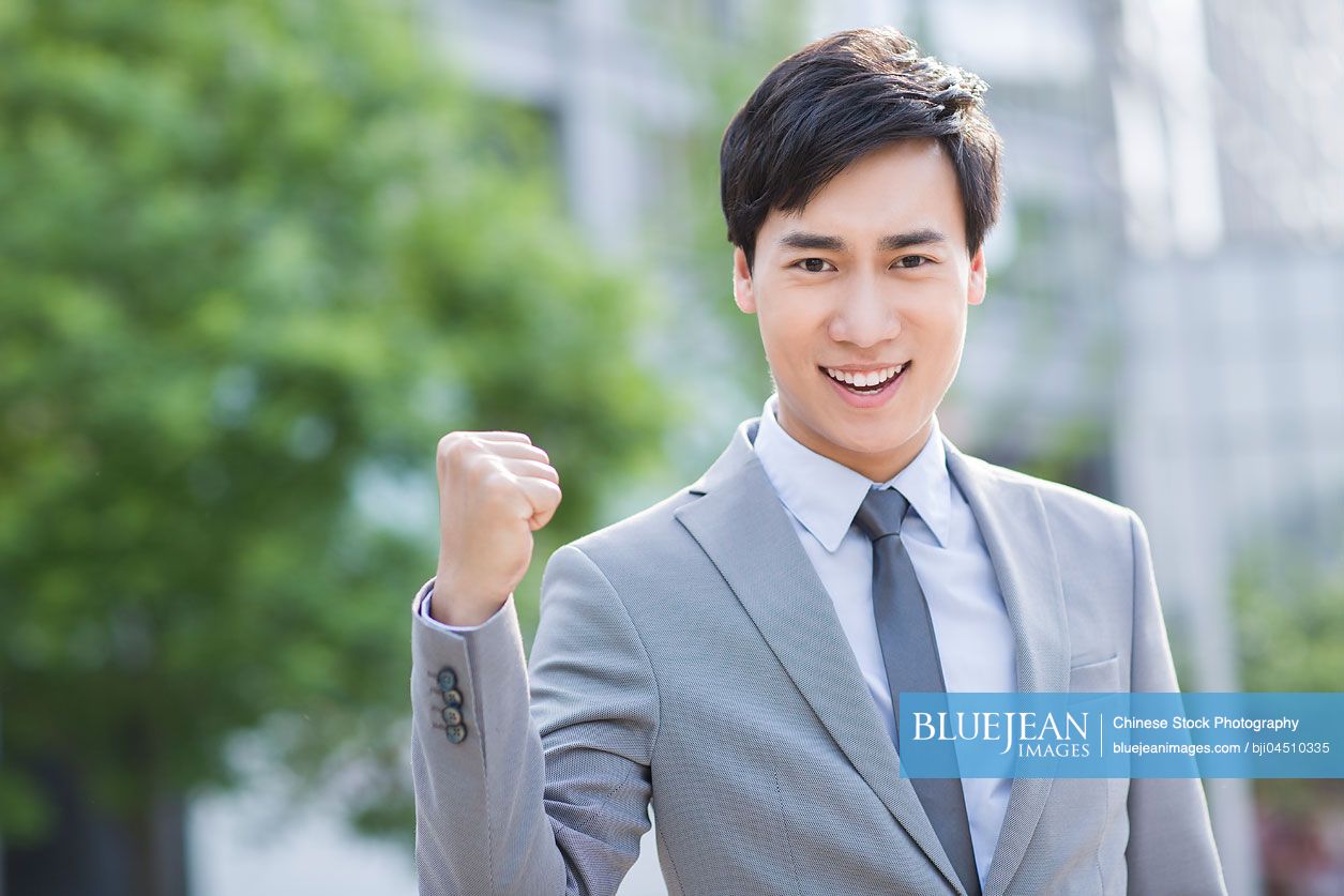 Young Chinese businessman cheering-High-res stock photo for download