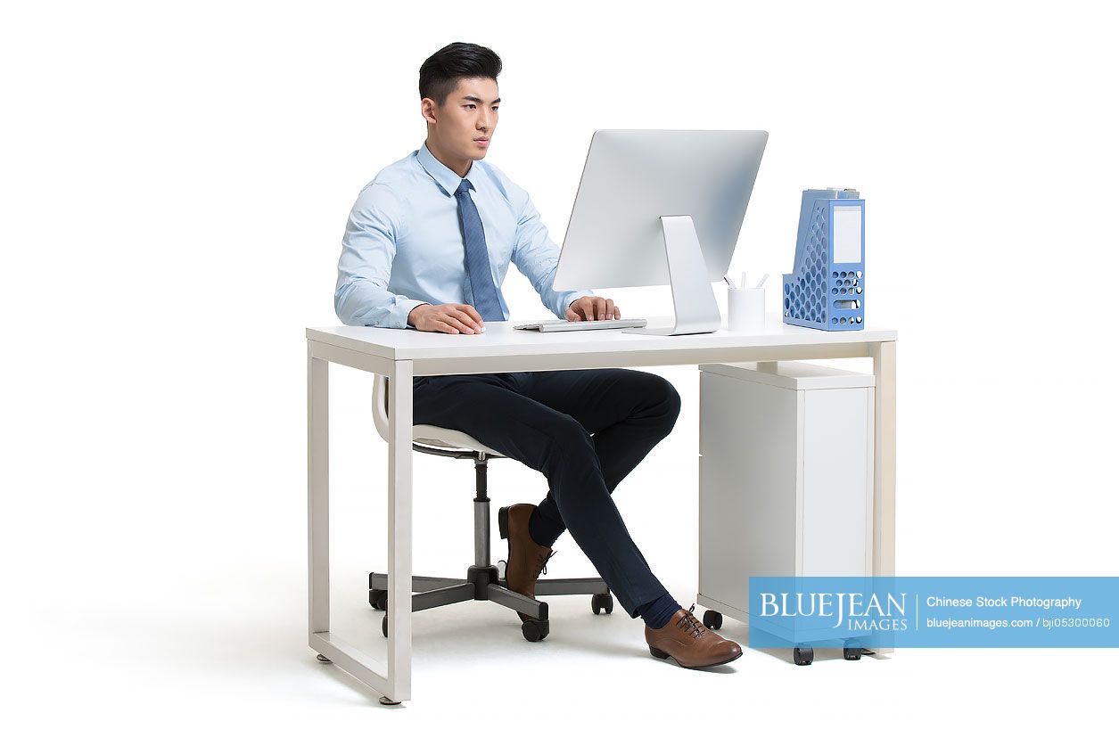 Serious young Chinese businessman working in office-High-res stock ...