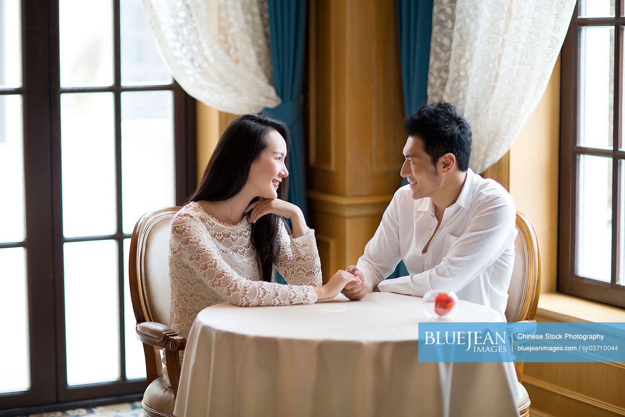 Young Chinese couple dating in restaurant-High-res stock photo for download