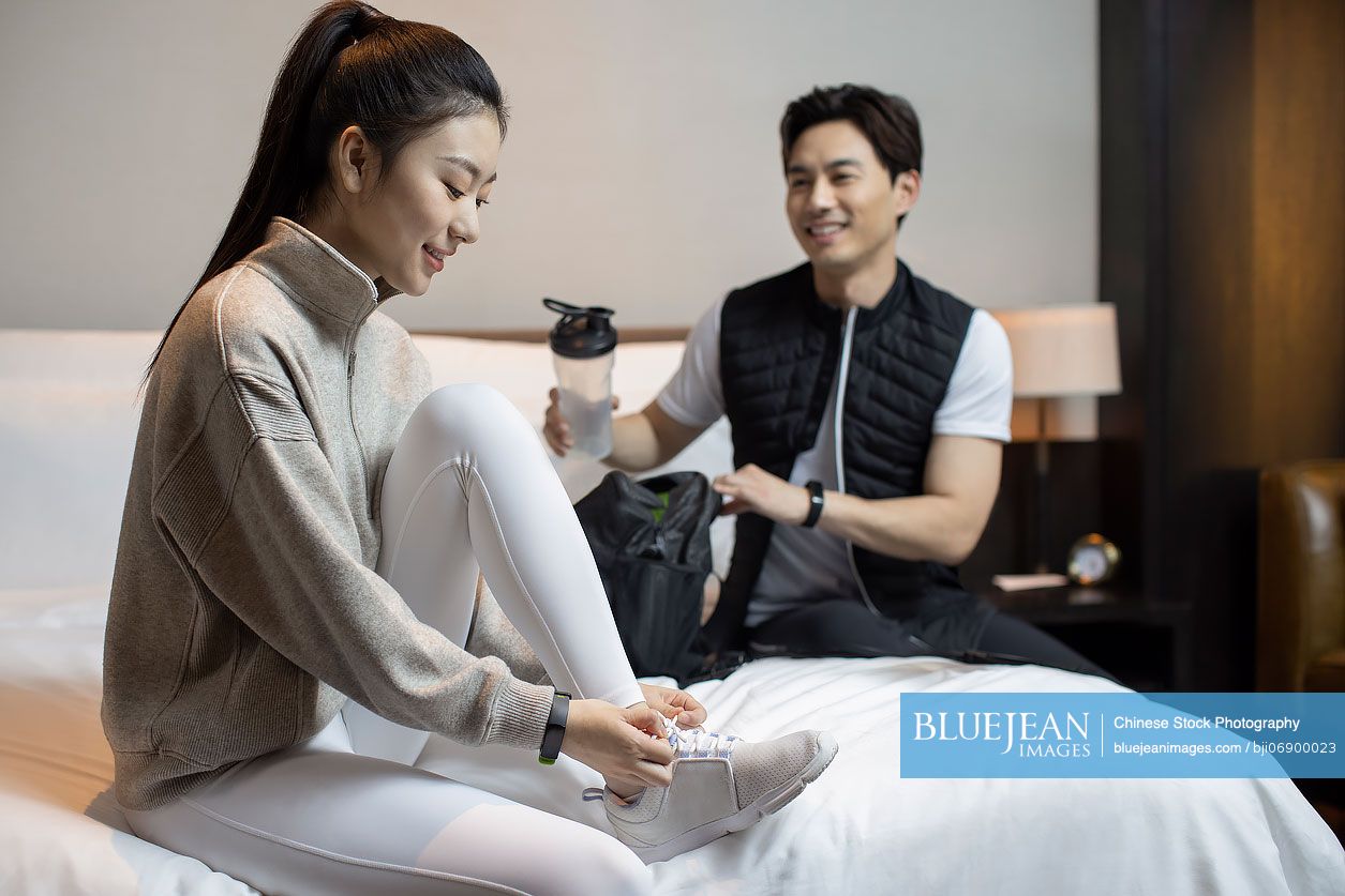 Young Chinese couple getting ready to go out and workout-High-res stock photo for download